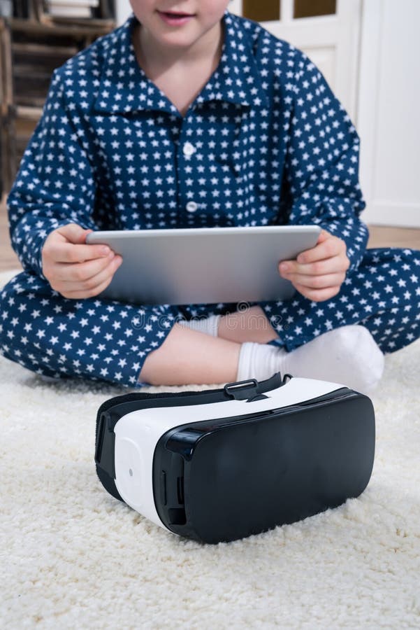 Boy with Virtual Reality Headset and Digital Tablet Sitting on Carpet ...