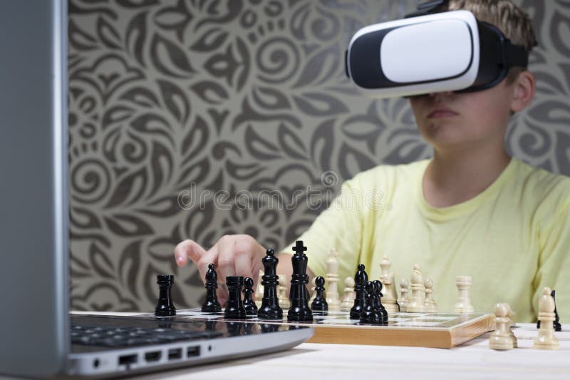 A Boy in a Virtual Reality Headset Plays Chess with a Laptop. Learning ...