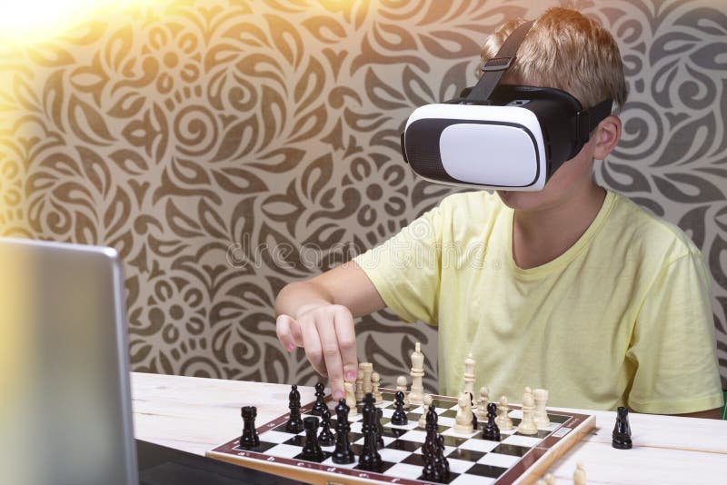 A Boy in a Virtual Reality Headset Plays Chess with a Laptop. Learning ...