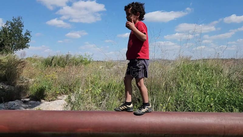 Boy Walking on a Metal Pipe Stock Video - Video of nature, pipe: 277048959