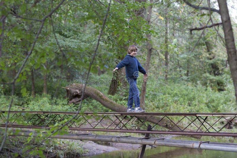 Boy Walking Over a Bridge in the Forest Stock Image - Image of outdoor ...