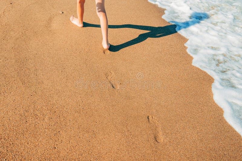 Boy Walking through the Sand of Ocean Beach, Sea Foam Wave Over His ...