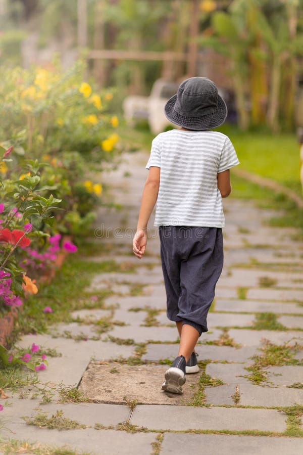 Boy Walking in a Tropical Garden Stock Image - Image of mode, lifestyle ...