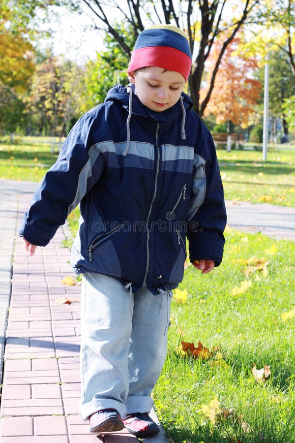 Boy walks in park stock photo. Image of fall, jacket - 11189264
