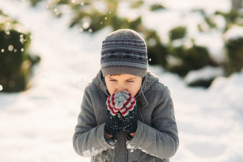 A Boy Warms His Hands from the Cold in Winter Stock Photo - Image of ...