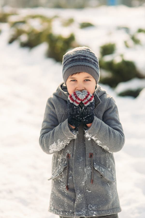 A Boy Warms His Hands from the Cold in Winter Stock Image - Image of ...