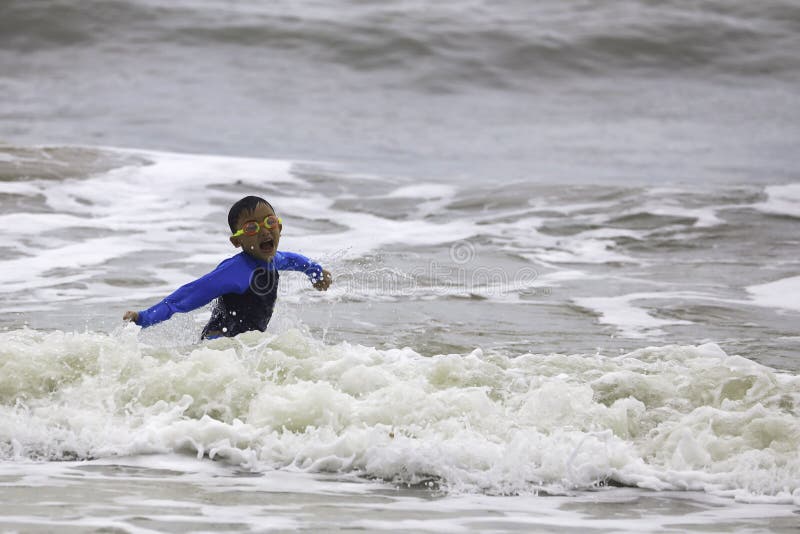 Boy Was Having Fun Playing with the Sea Wave at the Beach Stock Photo ...