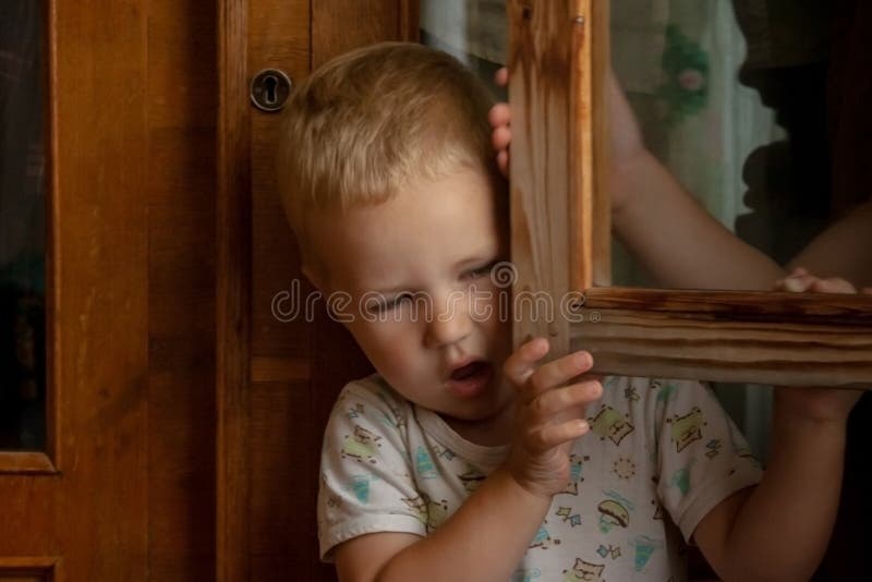 Boy Was Stuck between the Window Frame and the Closet in the Room Stock ...