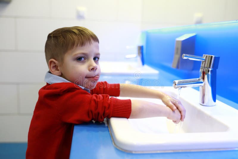 Boy washes his hands stock image. Image of beautiful - 164667443
