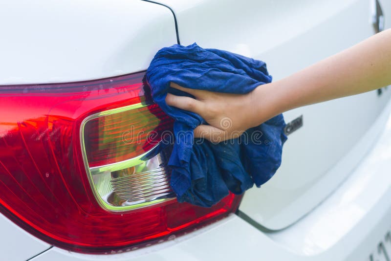 A Boy Washes a White Car with a Rag in the Summer at the Dacha Himself ...
