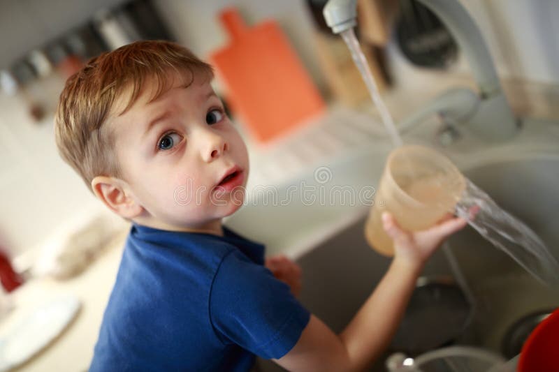 Boy washing dishes stock image. Image of independent - 105105557