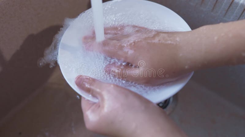 Boy wash plate in the sink stock footage. Video of sink - 274790210
