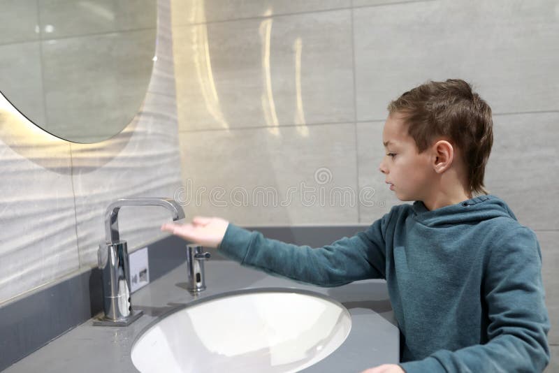Boy washing his hands stock photo. Image of childhood - 130451352