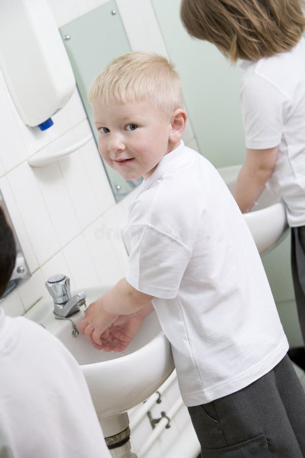 A Boy Washing His Hands in a School Bathroom Stock Photo - Image of ...
