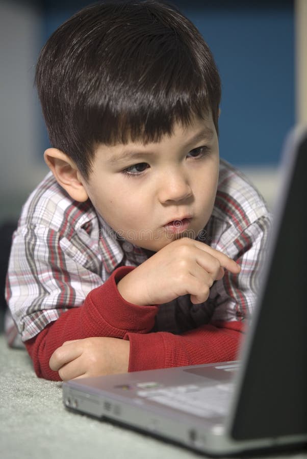 Boy watches laptop. stock photo. Image of person, learning - 12614966