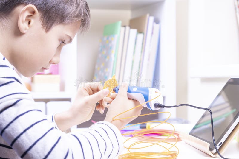 Boy Watching Video Tutorial on Tablet Computer and Creating with 3d Pen ...