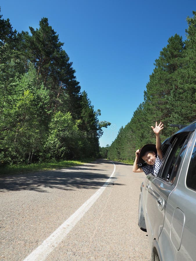 Boy Waving from the Moving Car. Travel Concept Stock Photo - Image of ...