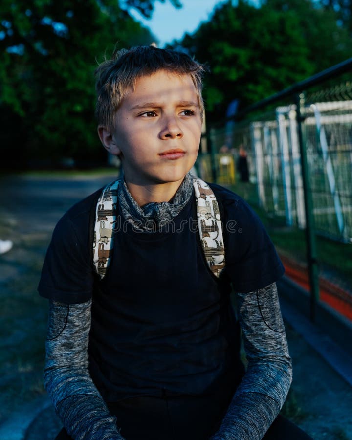 Boy Wearing a Black Shirt that Says Stay True Sits on the Ground Stock ...