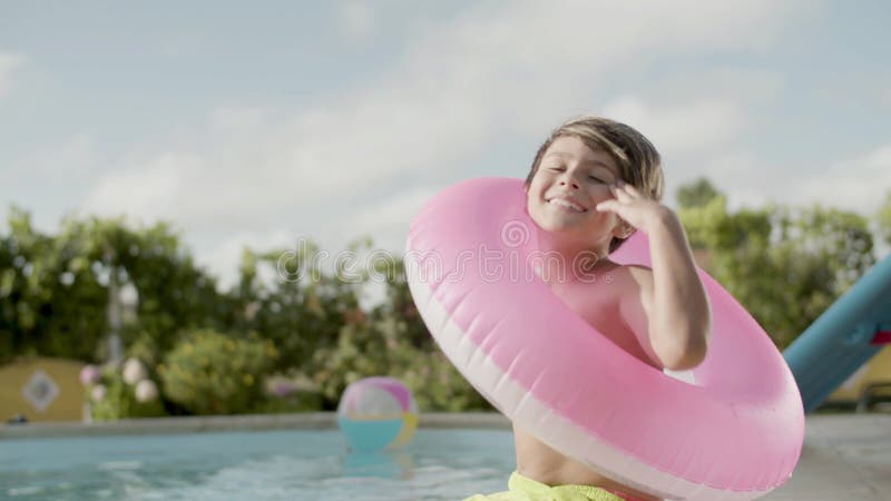 Boy Wearing Inflatable Ring, Sitting on Poolside and Smiling. Stock ...