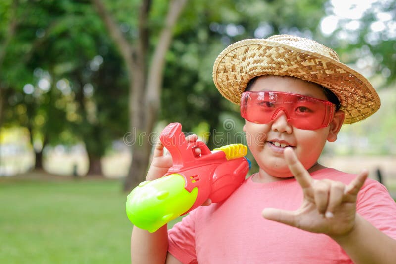 The Boy Wore Red Glasses and Carried Water Guns on Songkran Day. Stock ... The Boy Wore Red Glasses and Carried Water Guns on Songkran Day. Stock ...