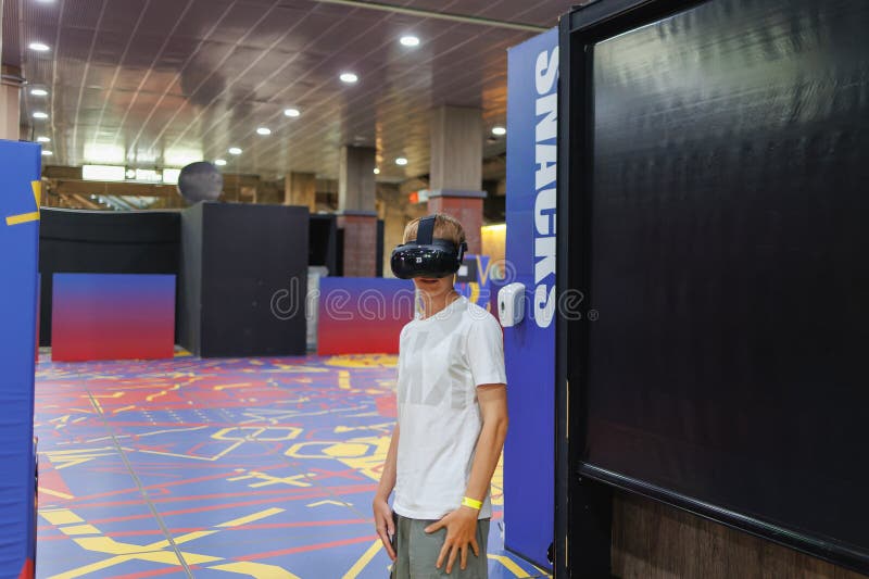 Boy Wearing a Virtual Reality Visor Inside a Play Space Set Up for the ...