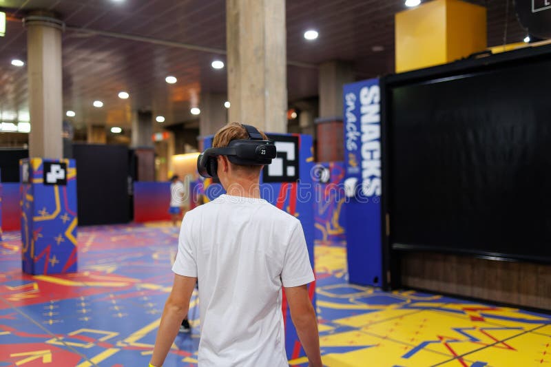 Boy Wearing a Virtual Reality Visor Inside a Play Space Set Up for the ...