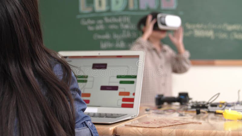 Boy Wearing VR Headset To Enter Metaworld while Girl Coding System ...