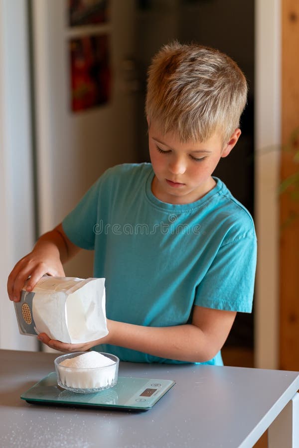 Boy Weighing Sugar from a Pack on a Kitchen Scale Stock Image - Image ...