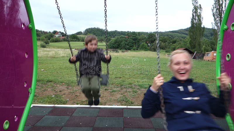 Boy and a Women Swaying on a Swing 02 Stock Video - Video of children ...