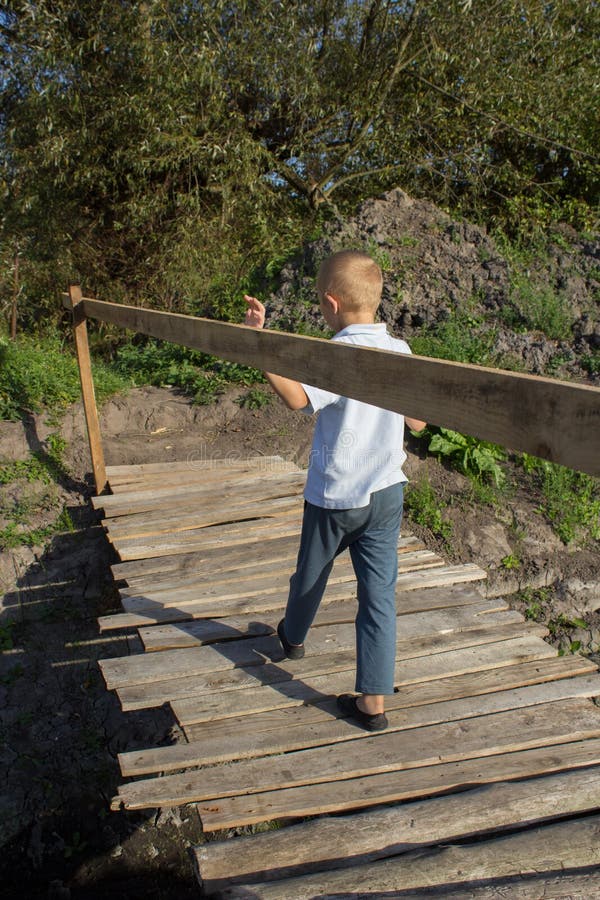 Boy on a wooden bridge stock image. Image of happiness - 65369327