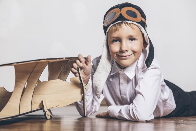 Boy with Wooden Plane Model and a Cap with Cap Designs Stock Photo ...