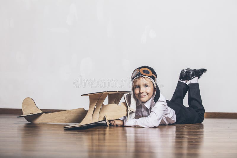 Boy with Wooden Plane Model and a Cap with Cap Designs Stock Image ...