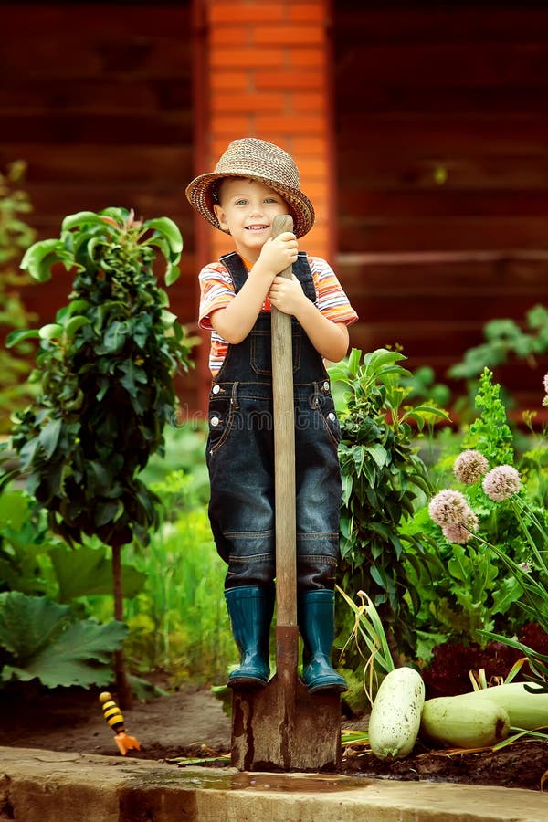 Boy working in the garden stock image. Image of earth - 30035687