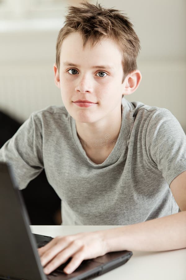 Boy Working on His Laptop Looking at Camera Stock Photo - Image of ...