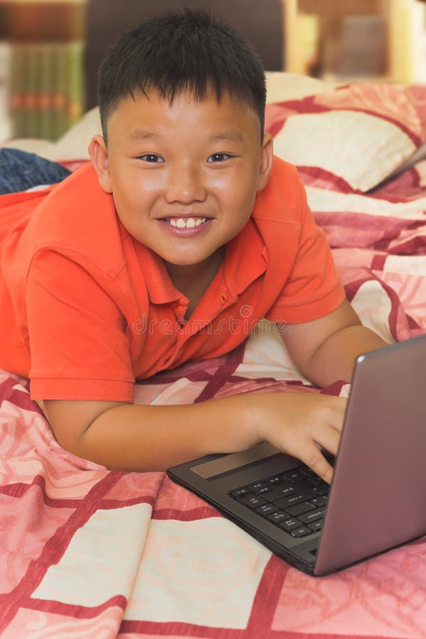 Asian Boy Working on a Laptop Computer Stock Photo - Image of cheerful ...