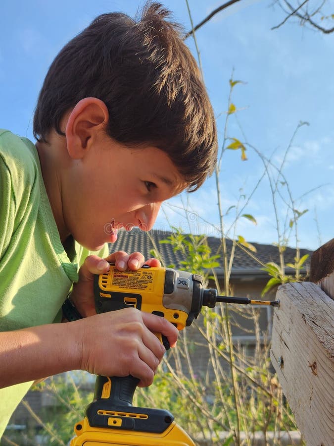 Boy Working with a Power Drill Stock Photo - Image of male, plant ...