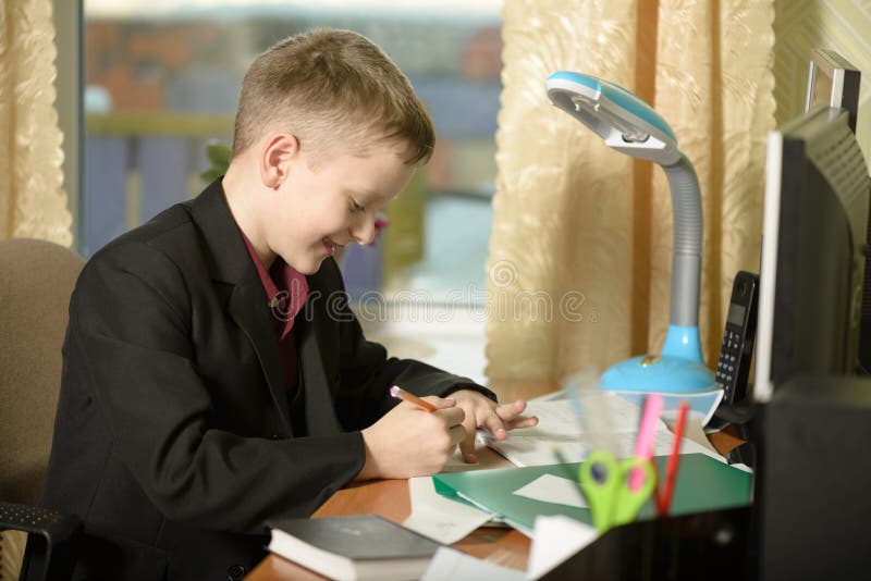 The Boy Works in His Office on a Personal Computer.he Writes a L Stock ...