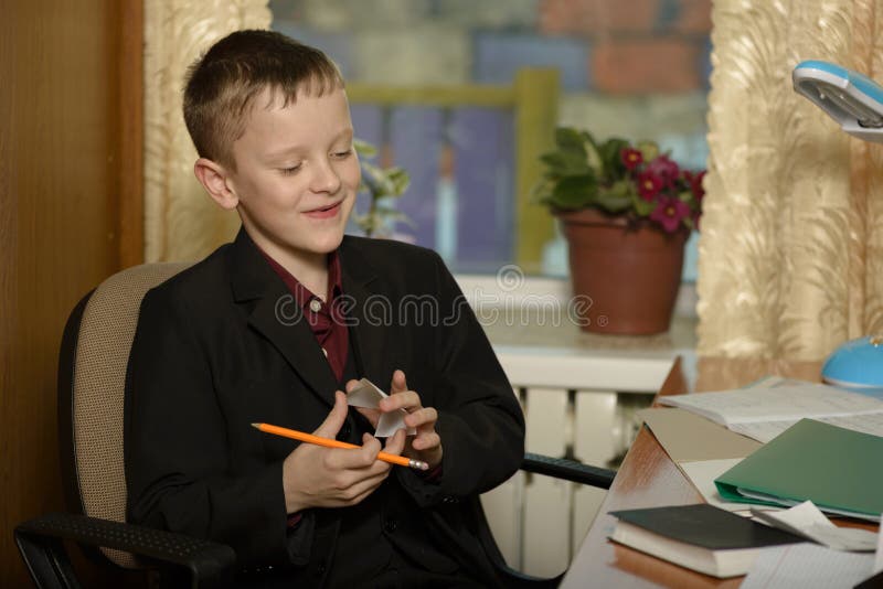 The Boy Works in His Office on a Personal Computer. he Writes a L Stock ...