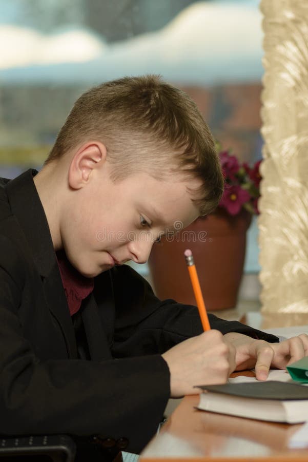 The Boy Works in His Office on a Personal Computer.he Writes a L Stock ...