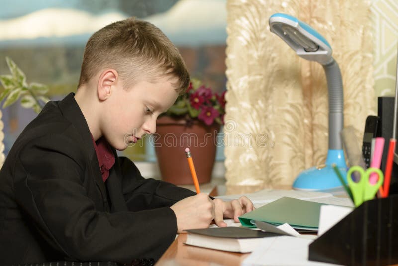 The Boy Works in His Office on a Personal Computer.he Writes a L Stock ...