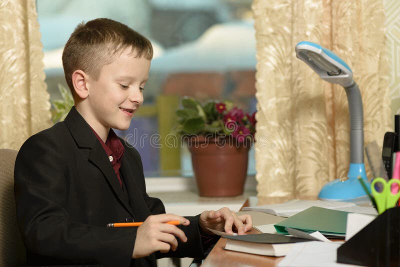 The Boy Works in His Office on a Personal Computer.he Writes a L Stock ...