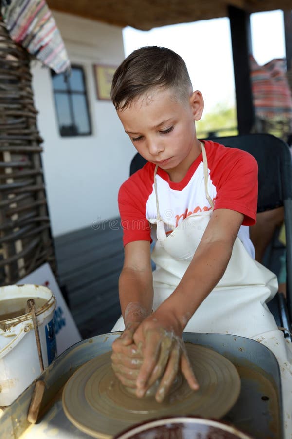 Boy works on pottery wheel stock image. Image of handmade - 160995951