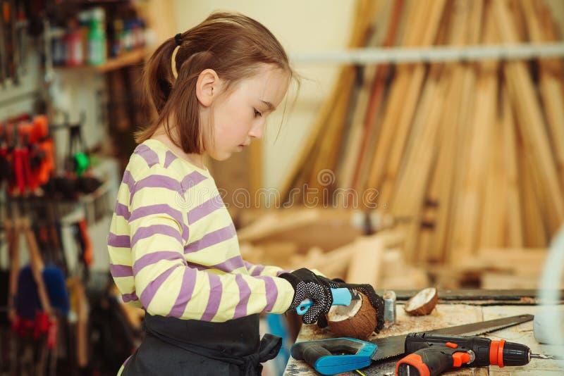Boy in the Workshop Makes Crafts with Coconut. Young Carpenter Working ...