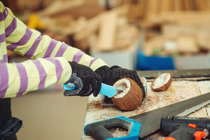 Boy in the Workshop Makes Crafts with Coconut. Young Carpenter Working ...