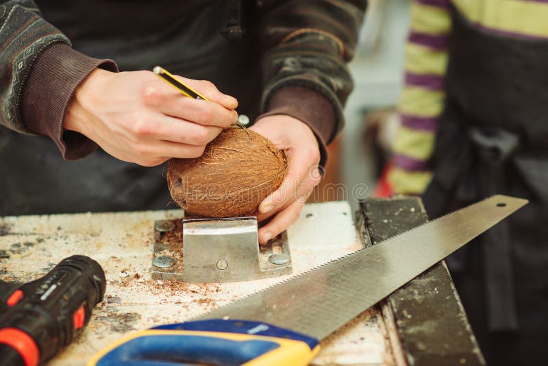 Boy in the Workshop Makes Crafts with Coconut. Young Carpenter Working ...