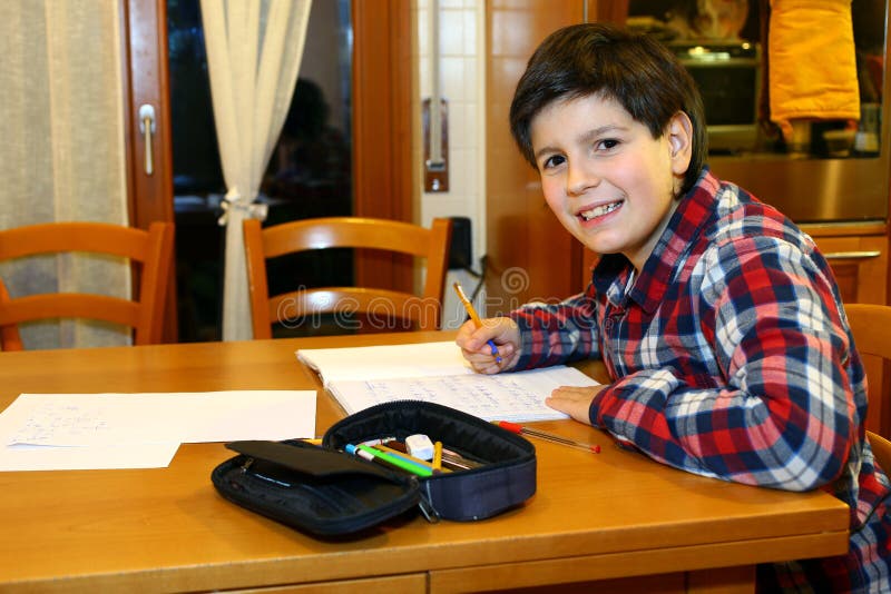 Boy writes on his notebook stock image. Image of work - 49408269