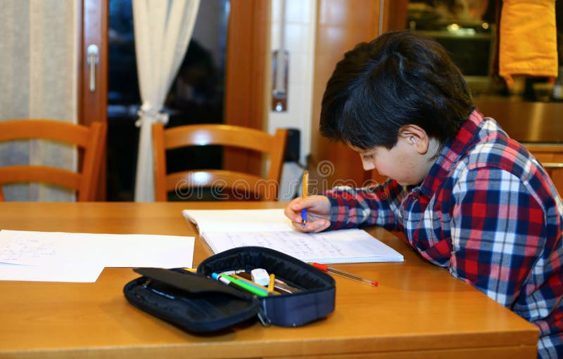 Boy writes on his notebook stock image. Image of exercises - 49408265