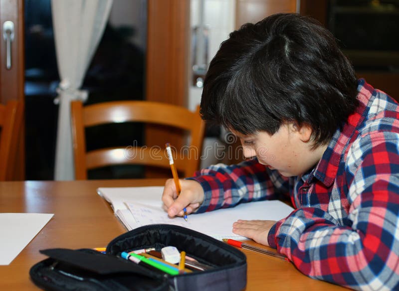 BOY writes on his notebook stock image. Image of childhood - 49409549