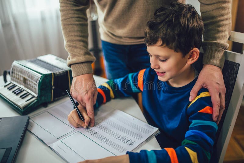 Boy Writes Musical Notes and Violin Key at Home Stock Photo - Image of ...