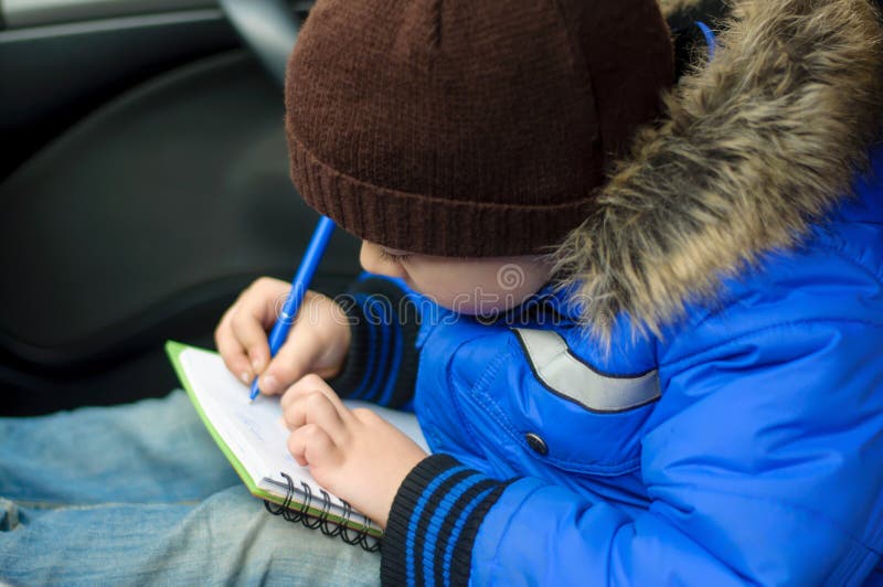 Boy Writes Notebook Sitting Inside Car Stock Photos - Free & Royalty ...